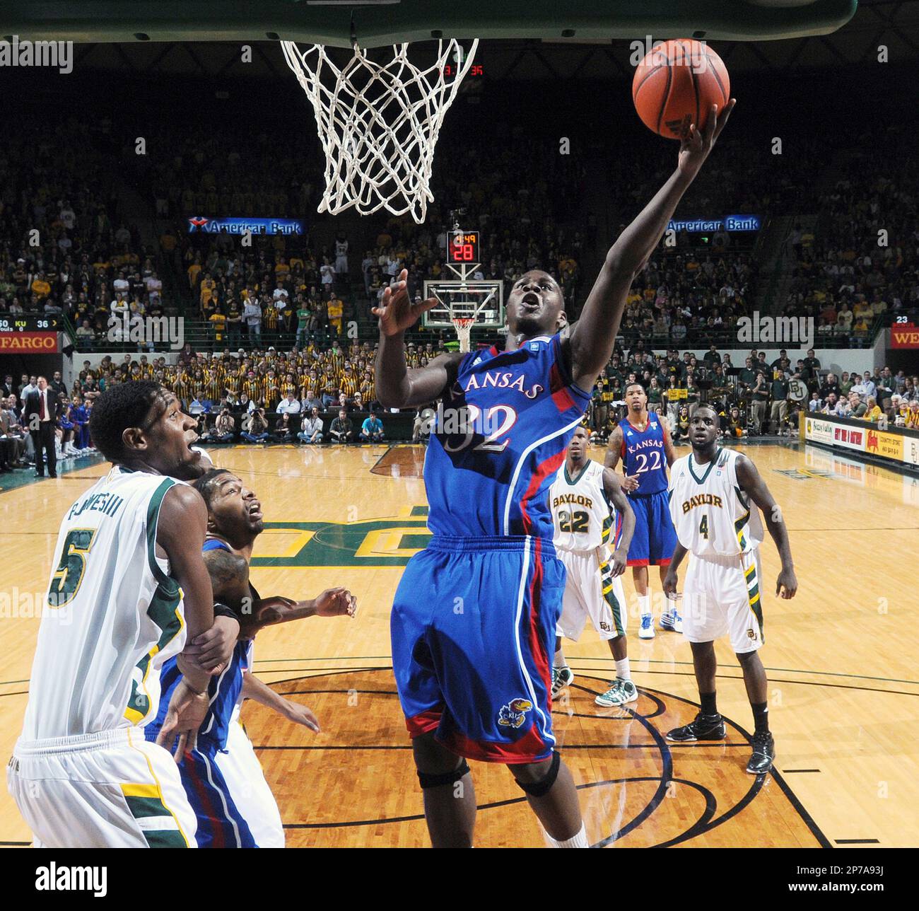 Kansas' Josh Selby, right, shoots past Baylor's Perry Jones III, left ...
