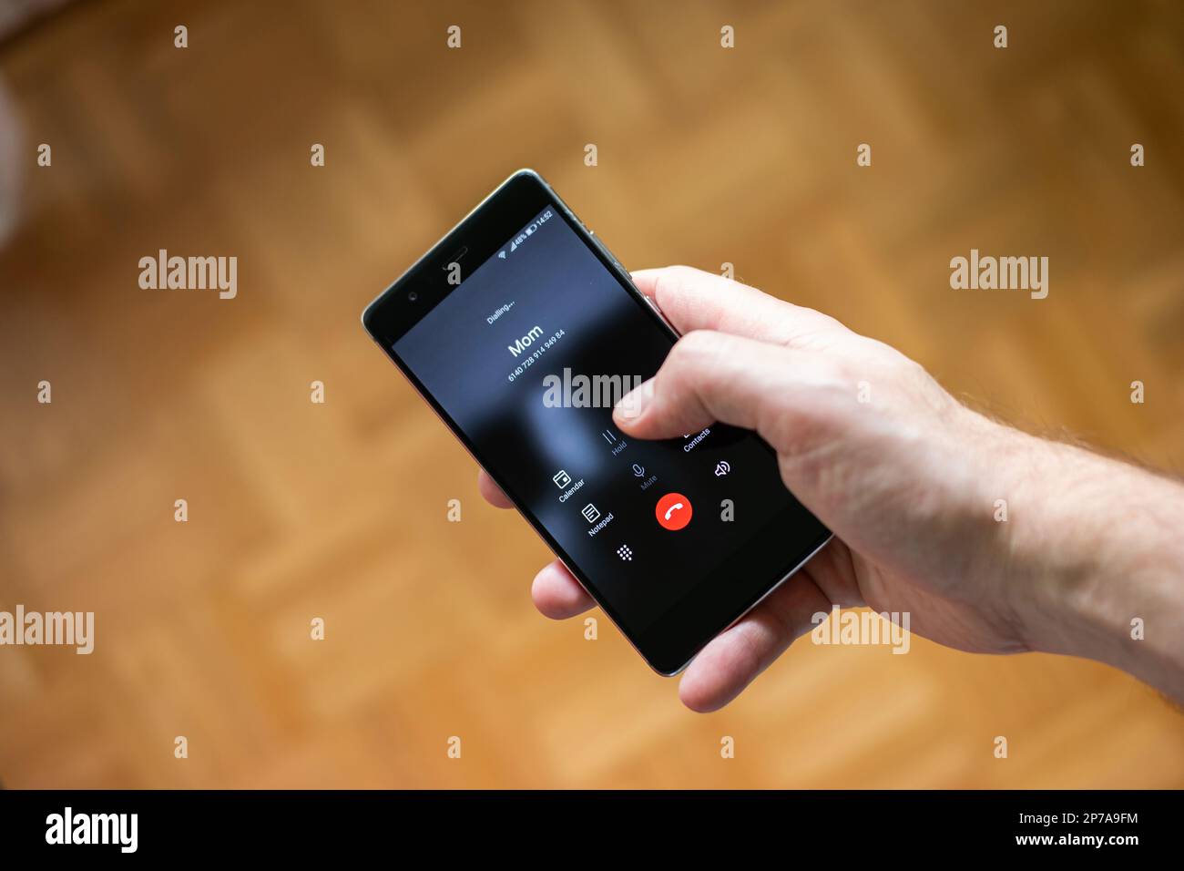 Caucasian male hand dialing his Mom on his cell phone. Close up shot ...