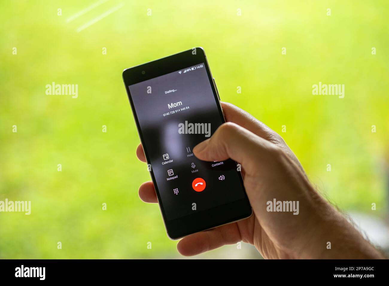 Caucasian male hand dialing his Mom on his cell phone. Close up shot ...