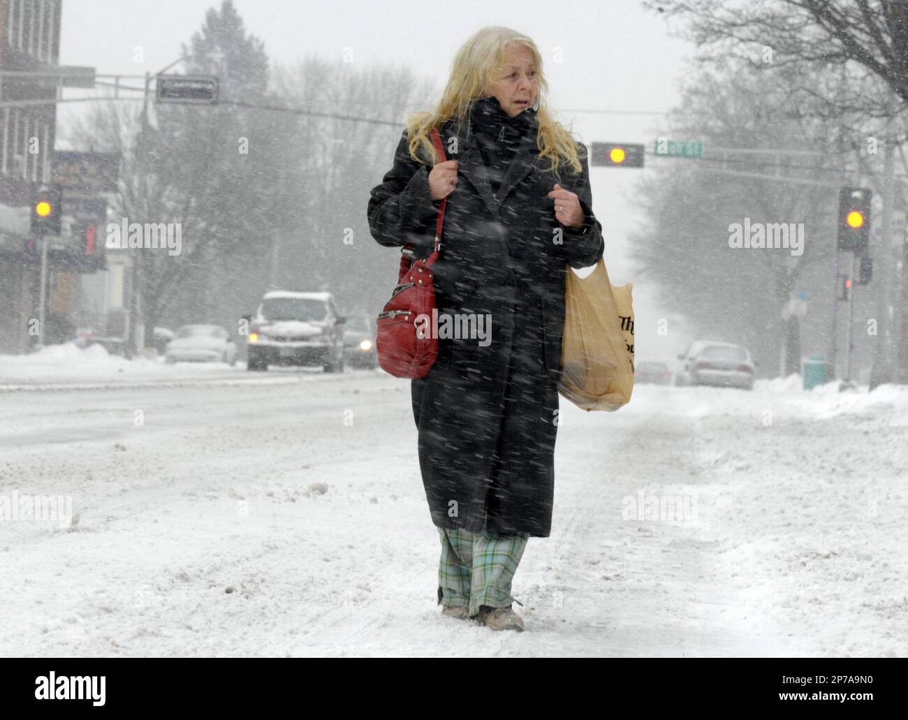 Vicki Salinas walks home from the store in the street, in Racine, Wis ...