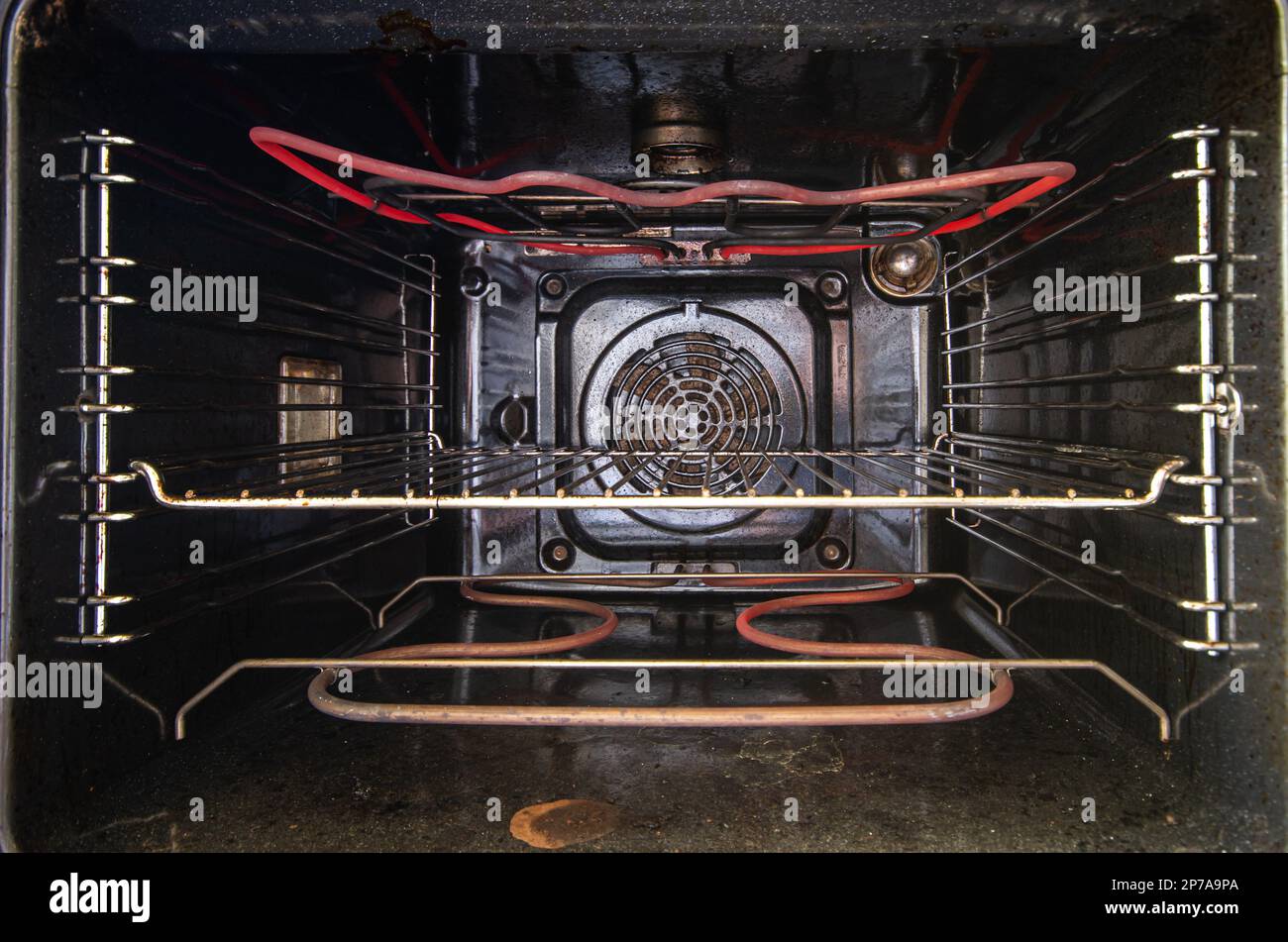 Dirty open household oven inside view close up wide shot. Glowing red ...