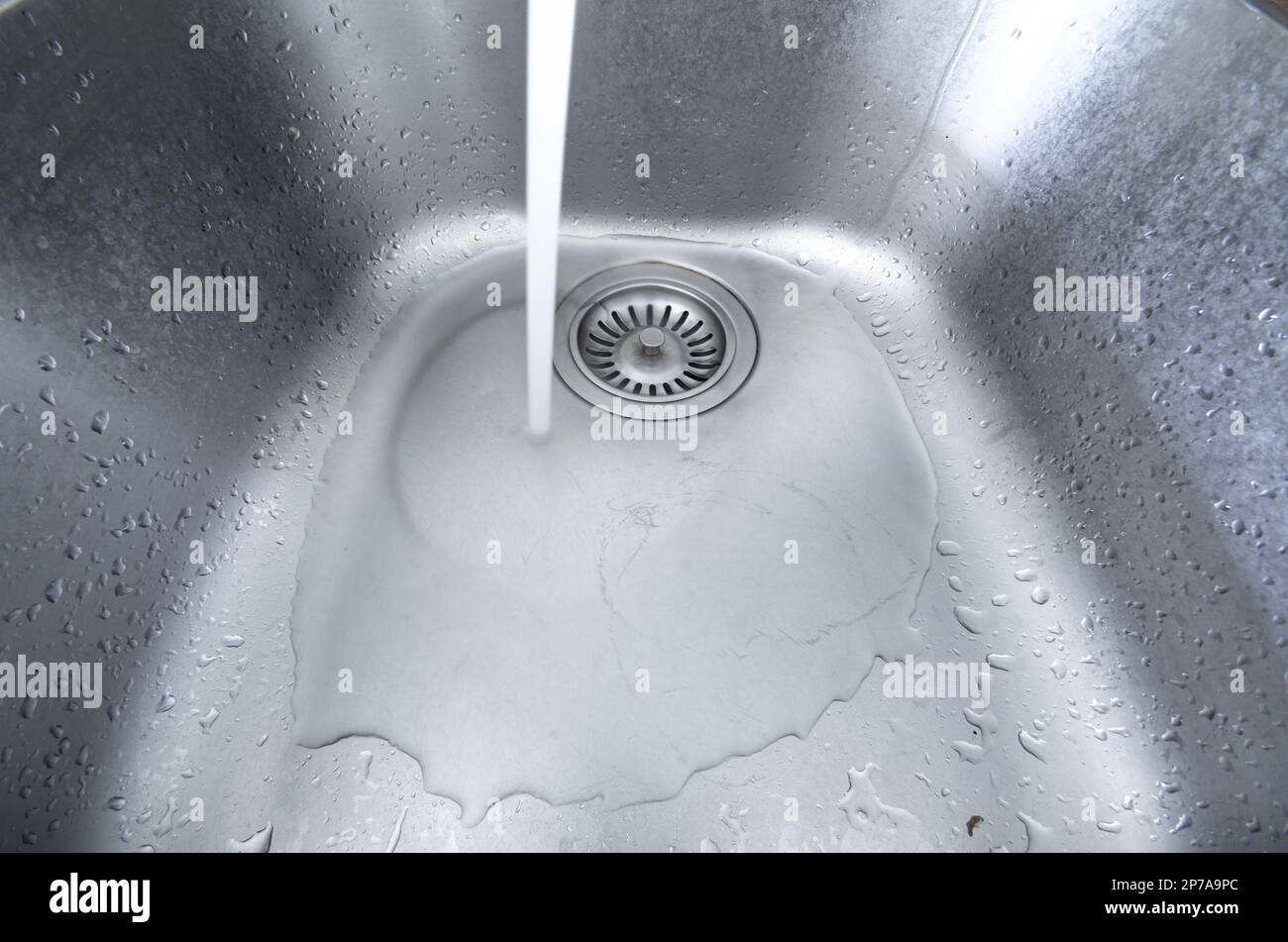 Water running down kitchen sink drain hi-res stock photography and ...