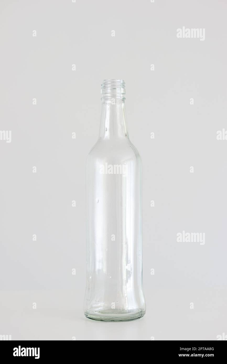 Empty clear glass bottle isolated on light gray background Stock Photo ...
