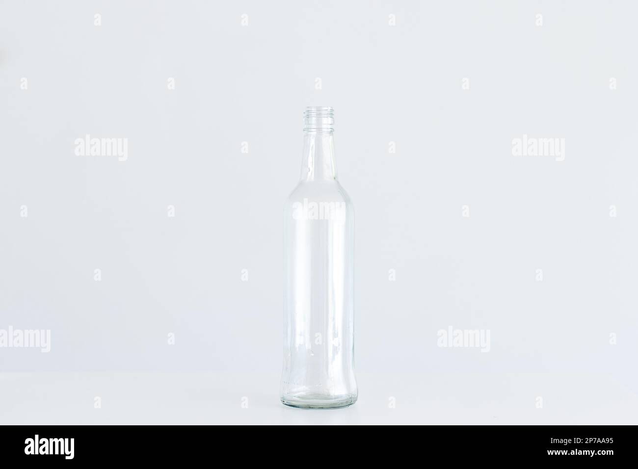 Empty clear glass bottle isolated on light gray background Stock Photo ...