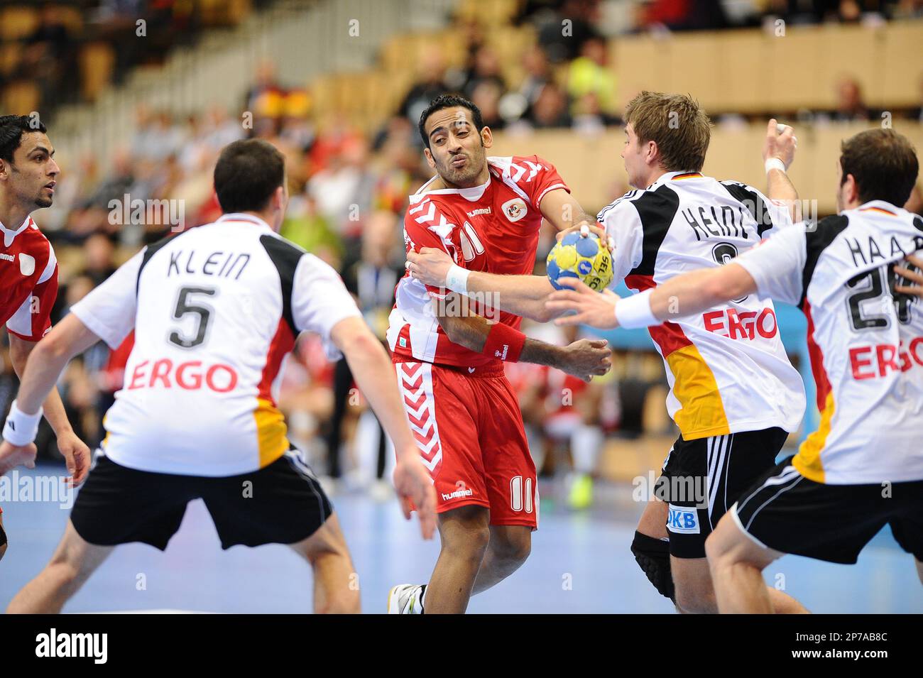 Bahrain's Sadiq Ali is caught between Germany's Dominik Klein, left ...