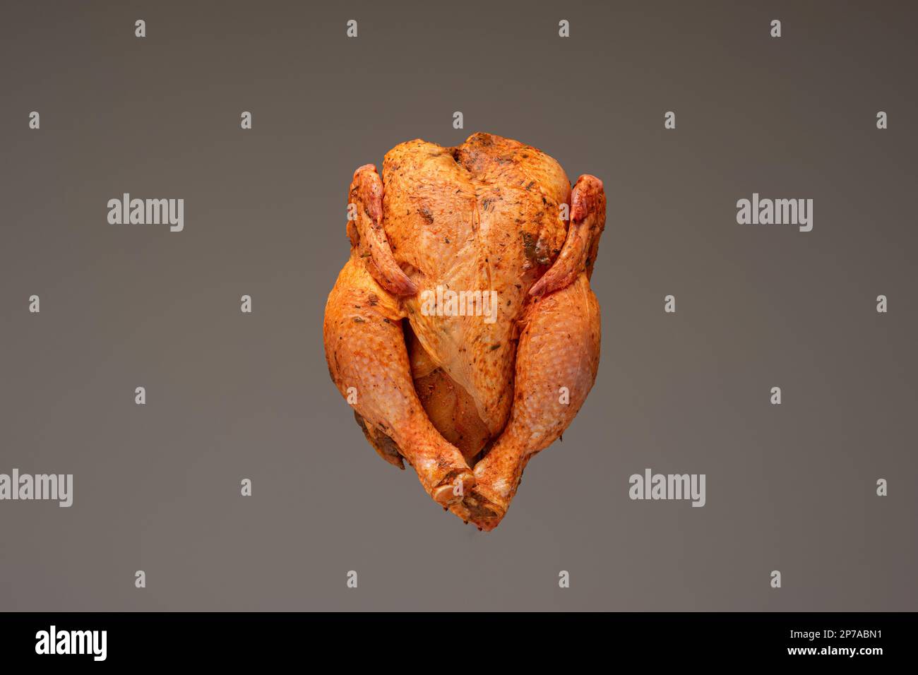 Fresh whole chicken, raw and ready seasoned. Close up studio shot ...