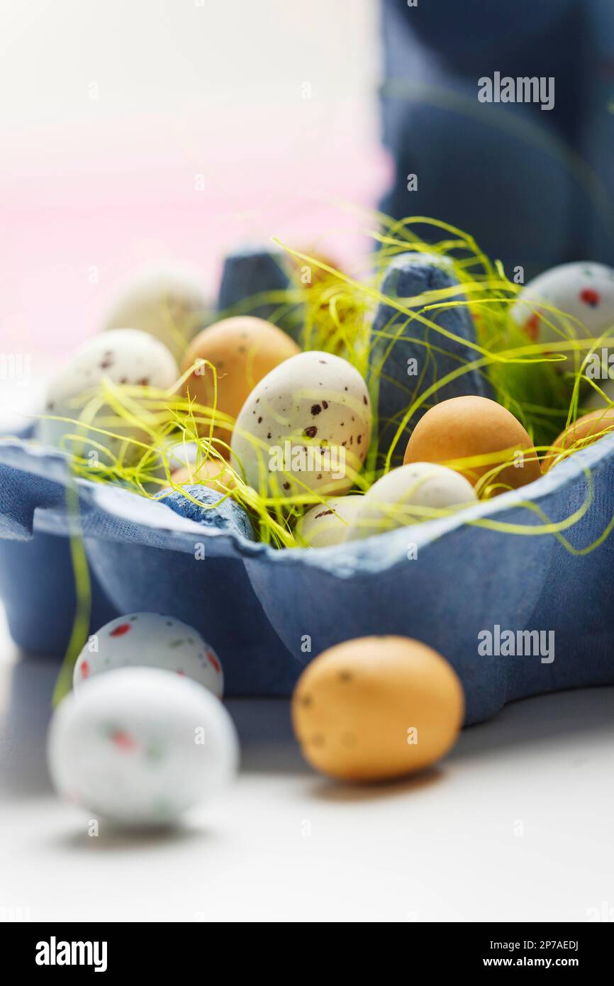 Blue Egg Box with Small Easter Eggs and Grass Stock Photo - Alamy
