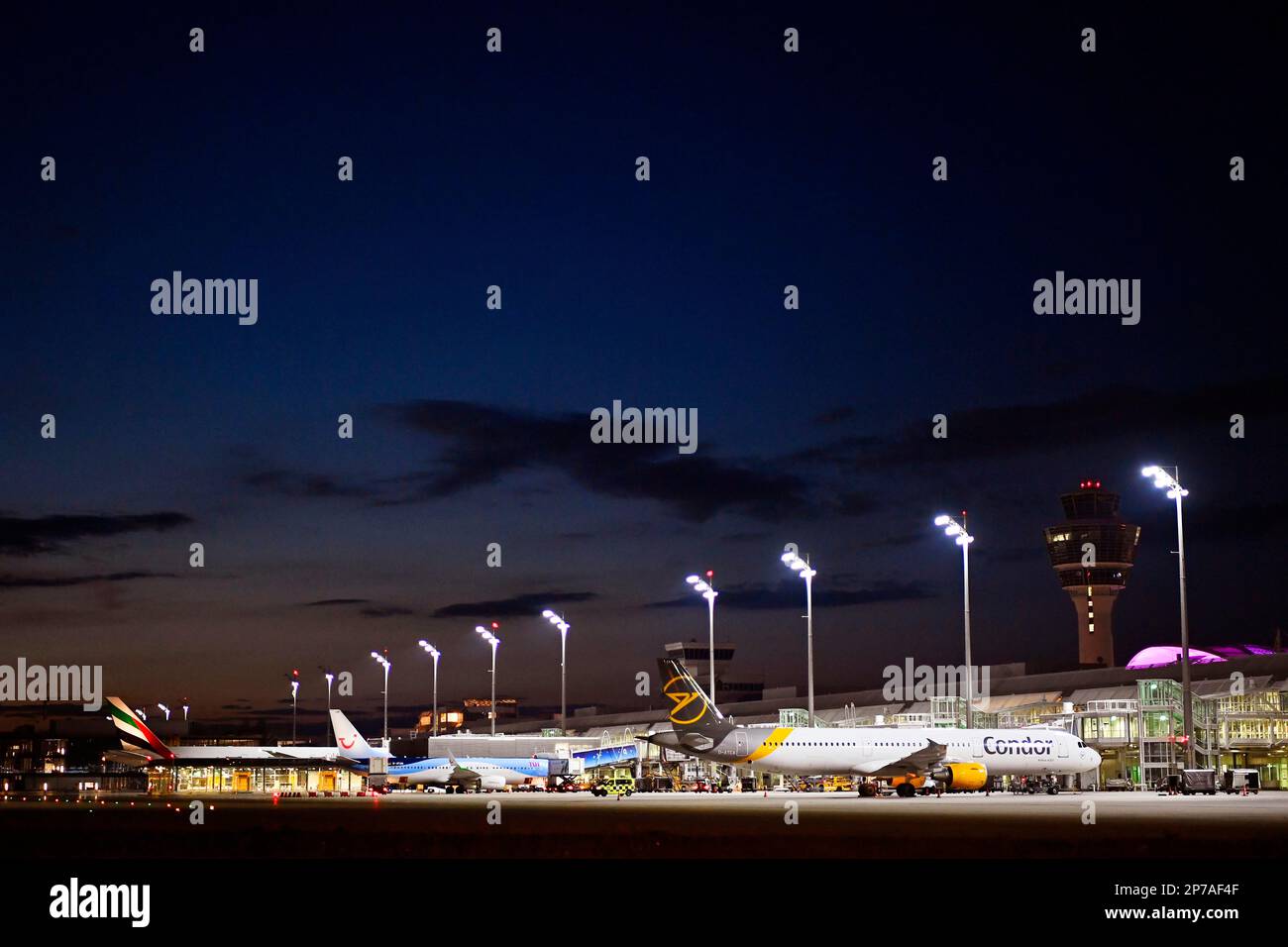 Terminal 1 at night with tower and Condor and TUI fly, and Emirates ...