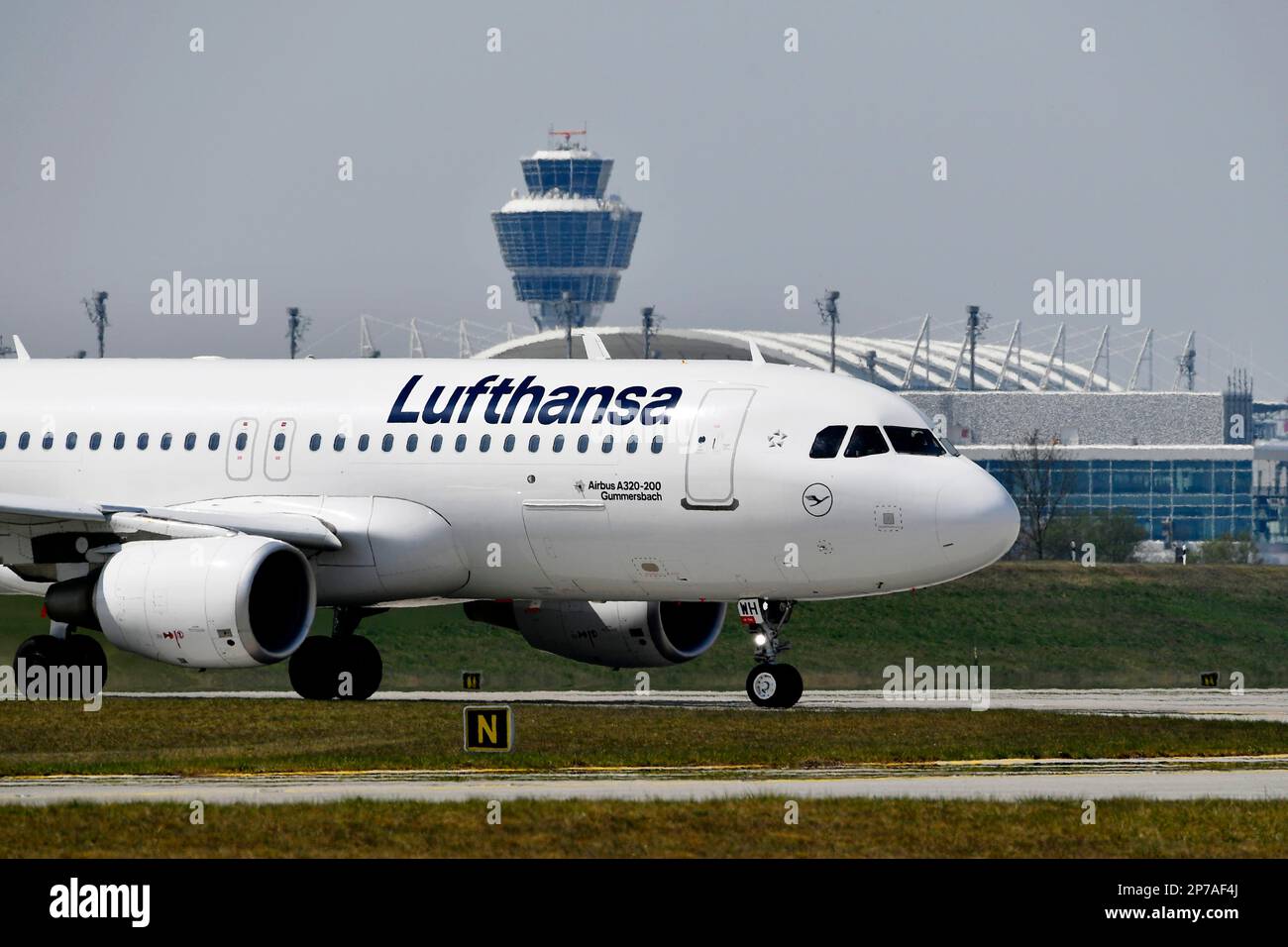 Lufthansa Airbus A320-200 taxiing on runway north with tower in the ...