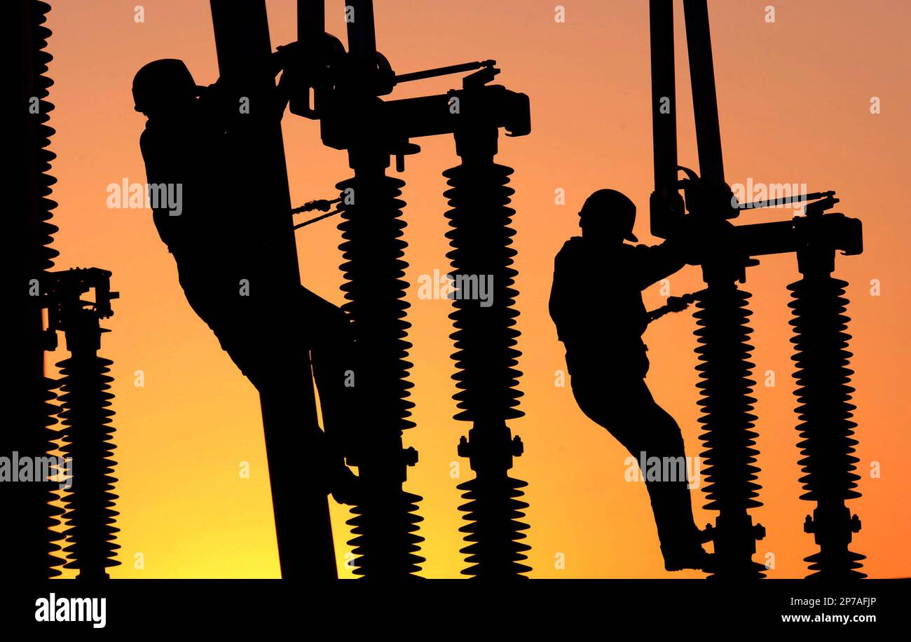 Workers work at a new transformer substation under construction in ...