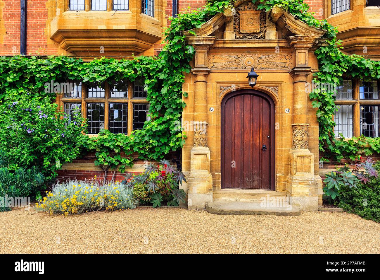Door with ornate columns and flowering plants, Trinity Hall College ...