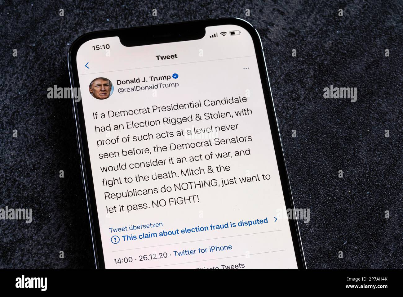 Smartphone with a Twitter tweet from Donald Trump with a message about ...