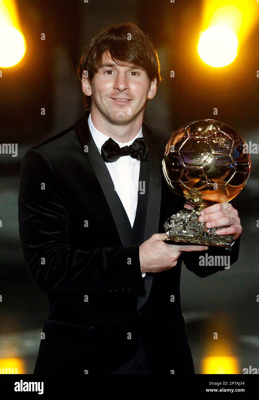 Argentina's soccer player Lionel Messi holds the trophy after he was ...
