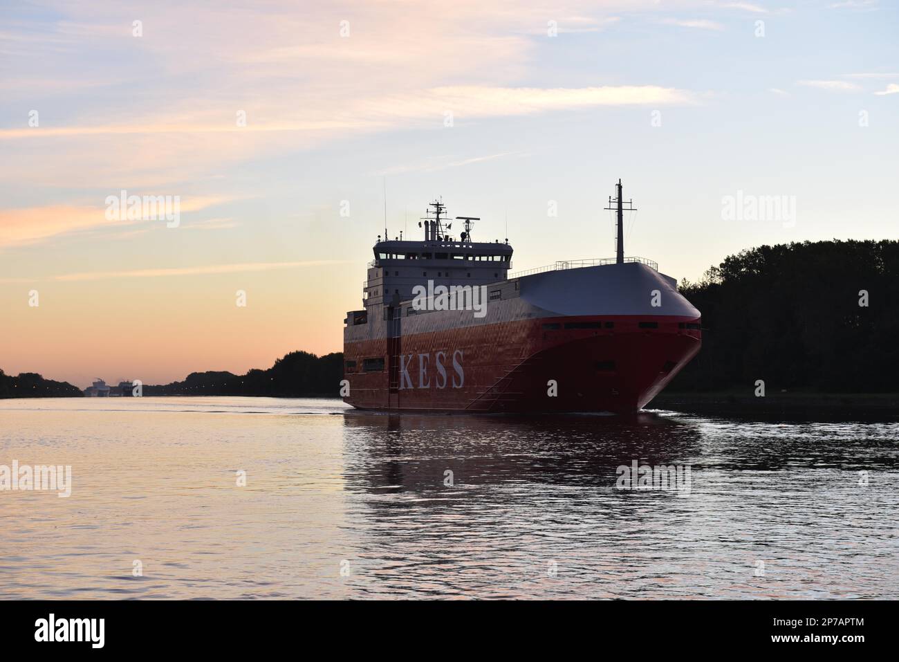 Cargo ship KESS sailing at sunrise in the Kiel Canal, Schleswig ...