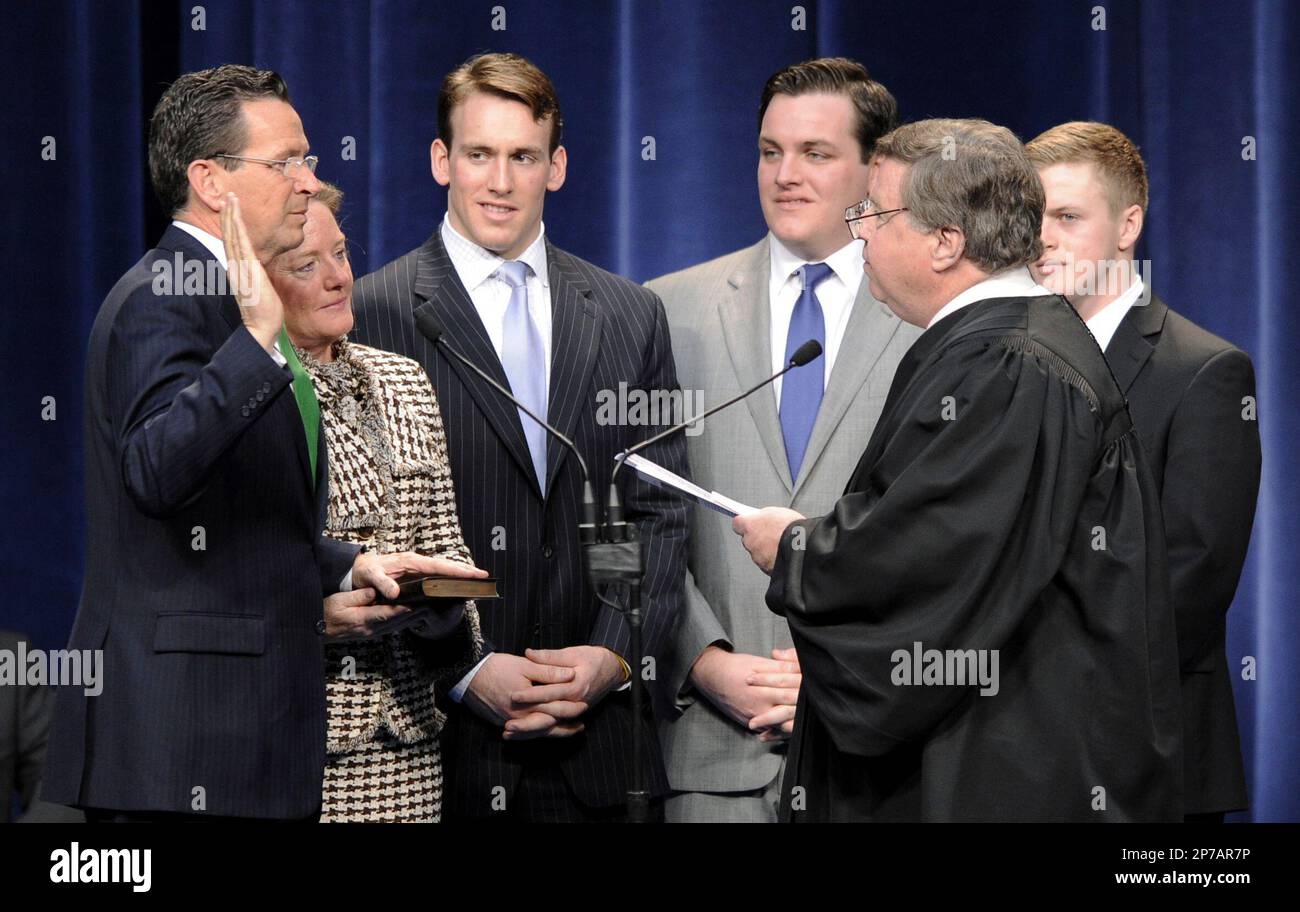 With his wife Cathy and sons at his side, Dan Malloy, left, is sworn in ...