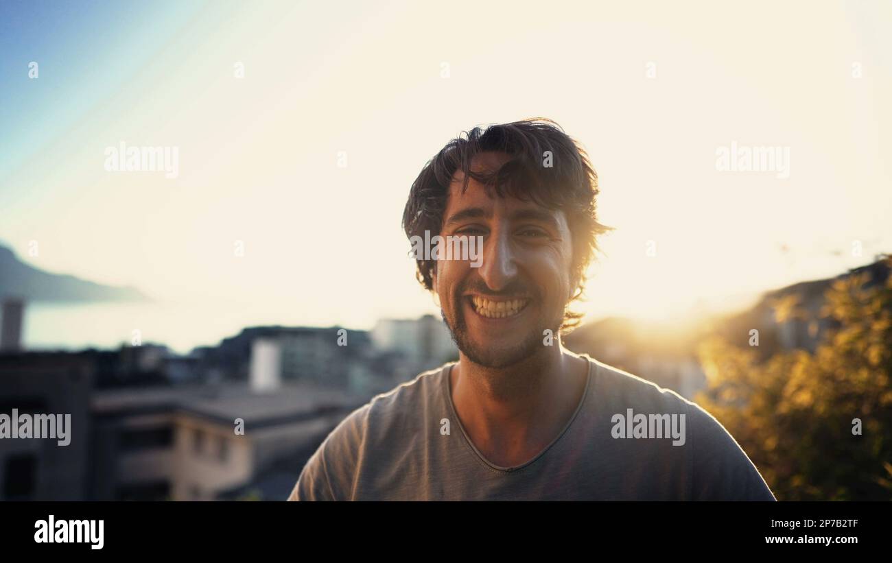 One happy casual man laughing and smiling standing outdoors in summer ...