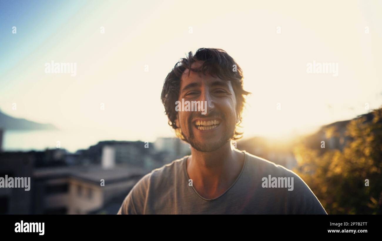One happy casual man laughing and smiling standing outdoors in summer ...