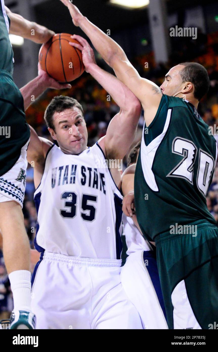 Utah State's Nate Bendall (35) holds on to the ball while being ...