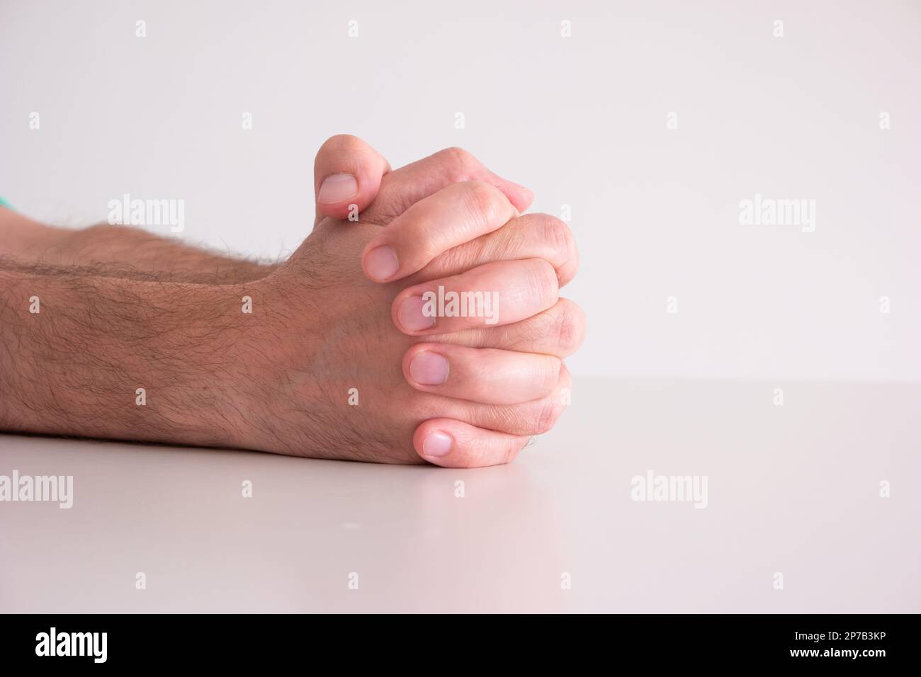 Caucasian male hands clutched together in prayer, isolated on white ...
