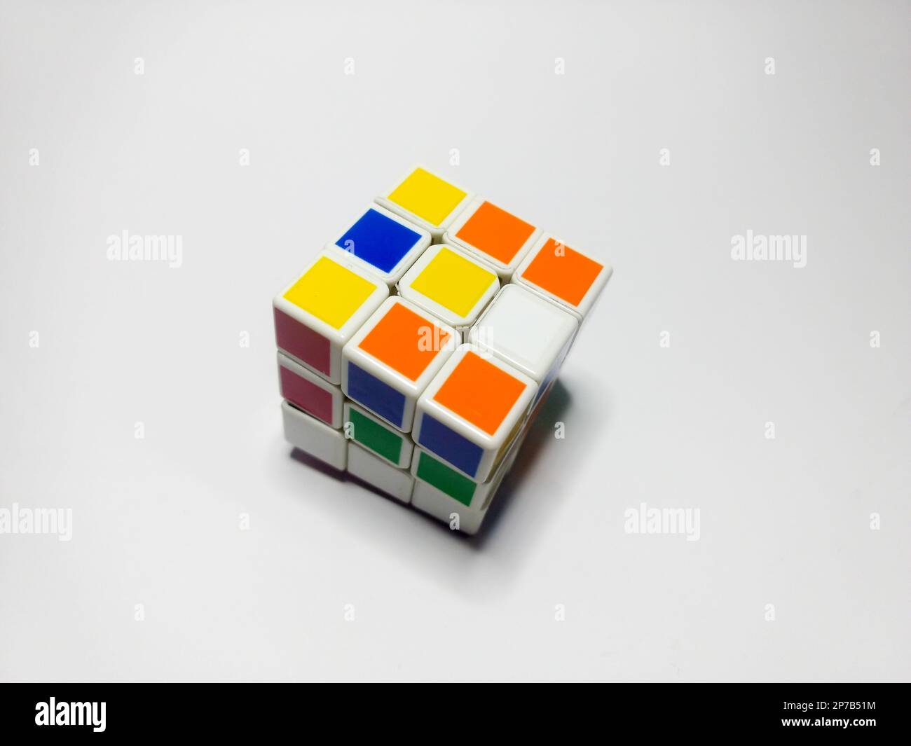 A Rubik's Cube placed on a white surface, with its individual squares in differing colors Stock ...