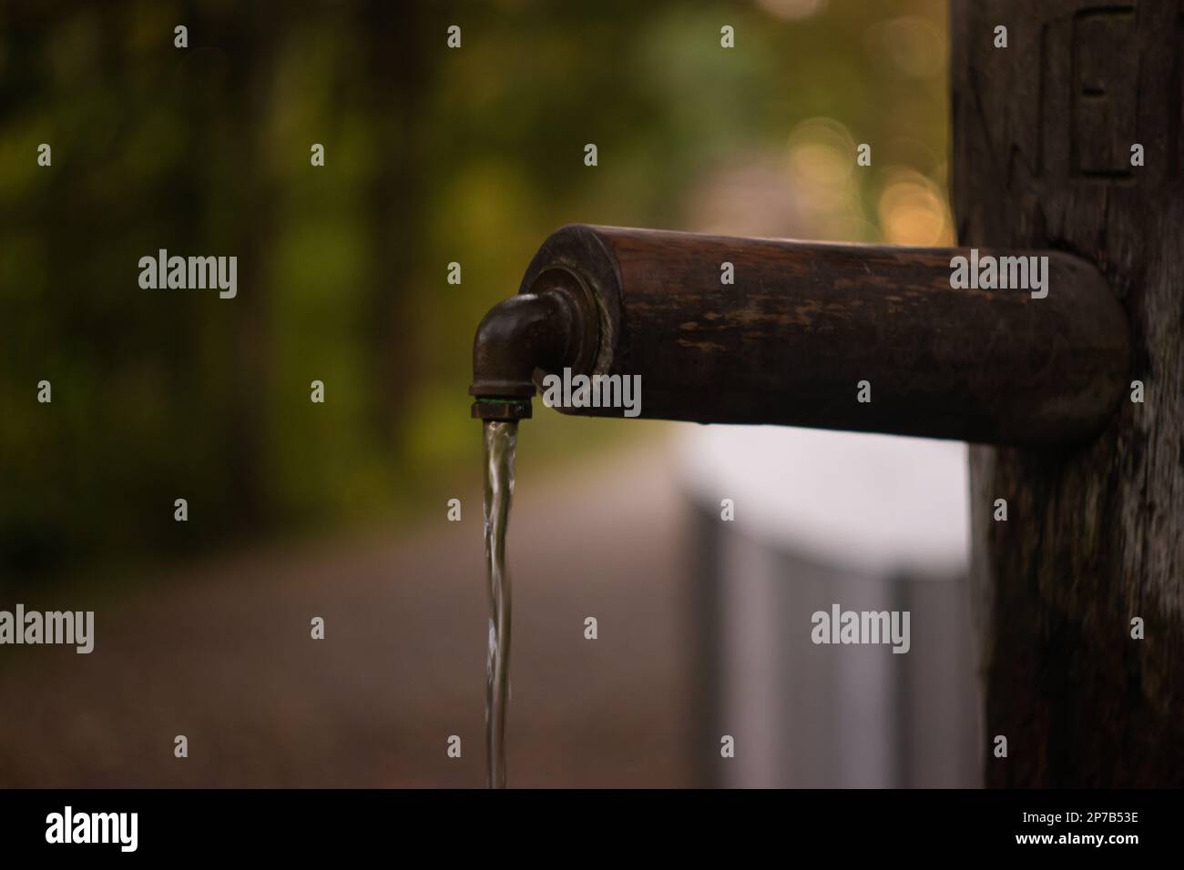 Old vintage tap drinking water fountain in a forest in Europe. Close up ...
