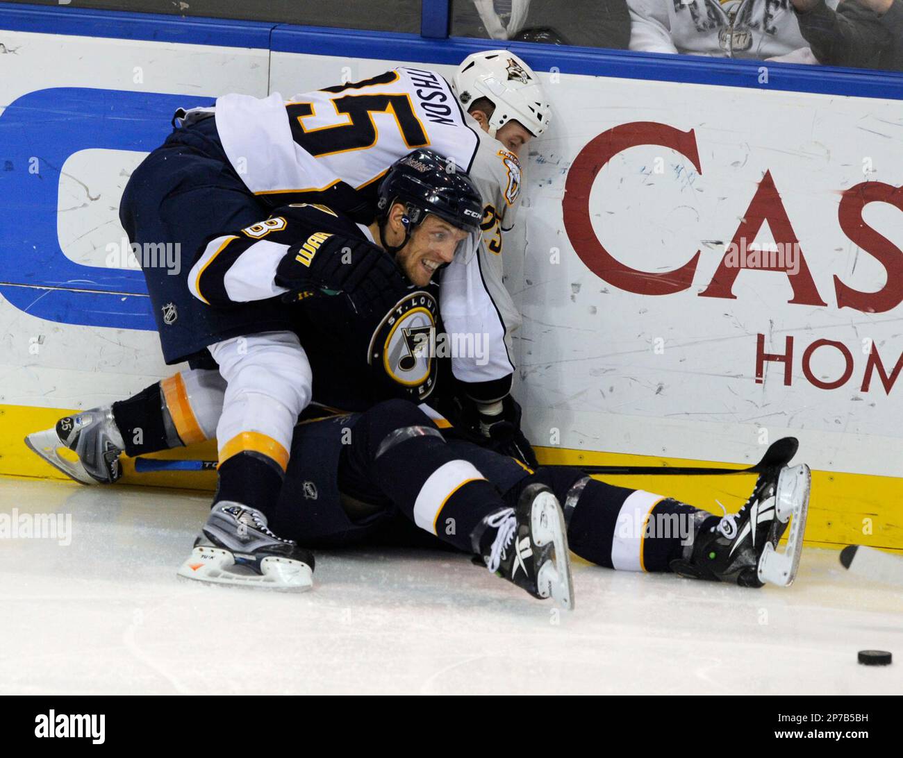 St. Louis Blues' Jay McClement, bottom, battles with Nashville ...