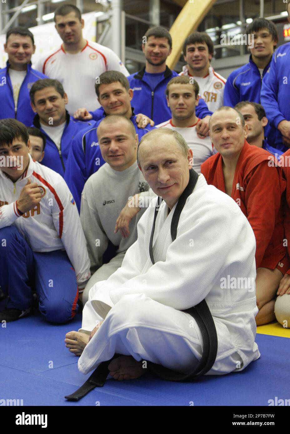 Russia's Prime Minister Vladimir Putin, center, pose with sportsmen ...