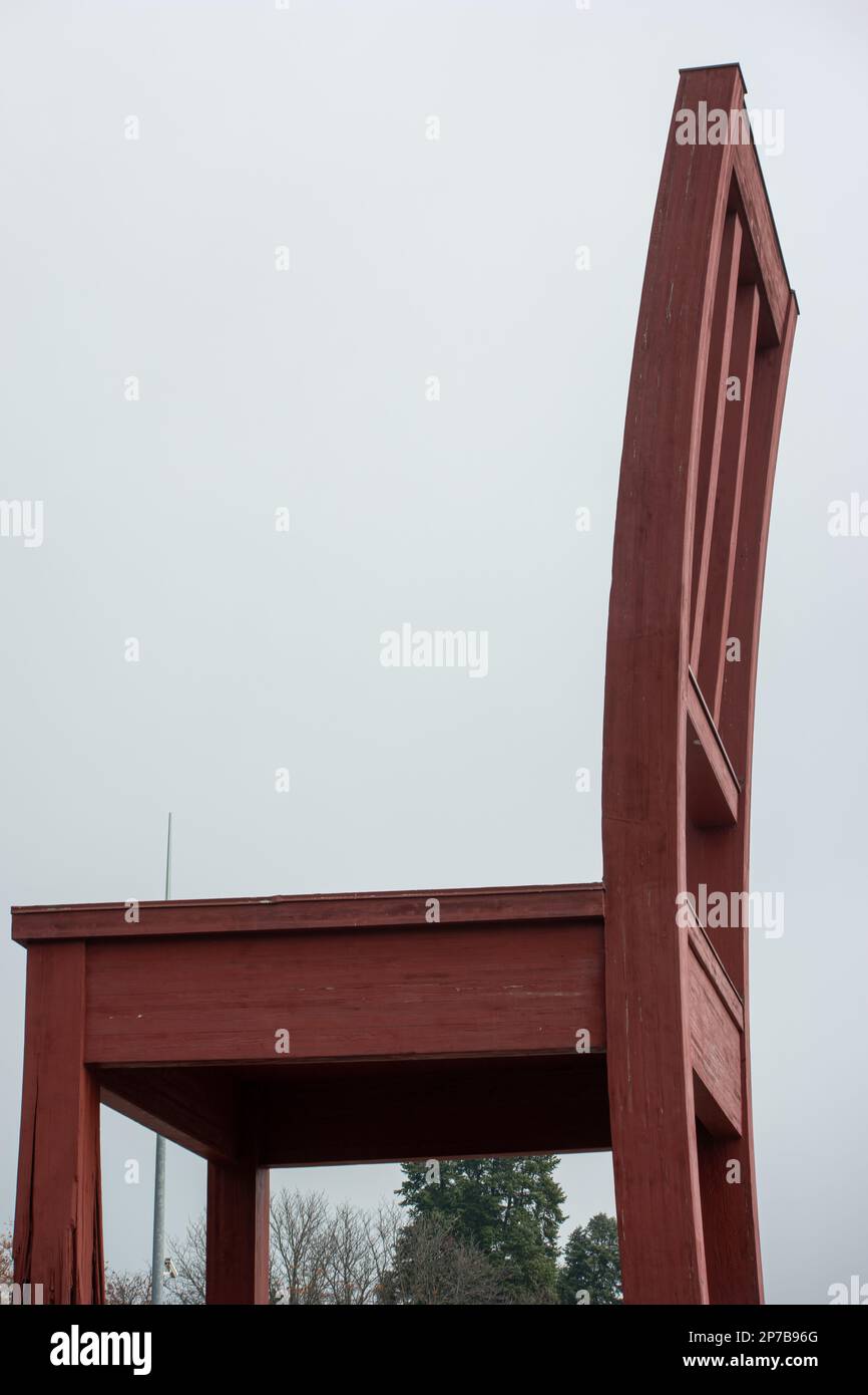 Famous wooden broken chair sculpture in Geneva. Cloudy sky, no people ...