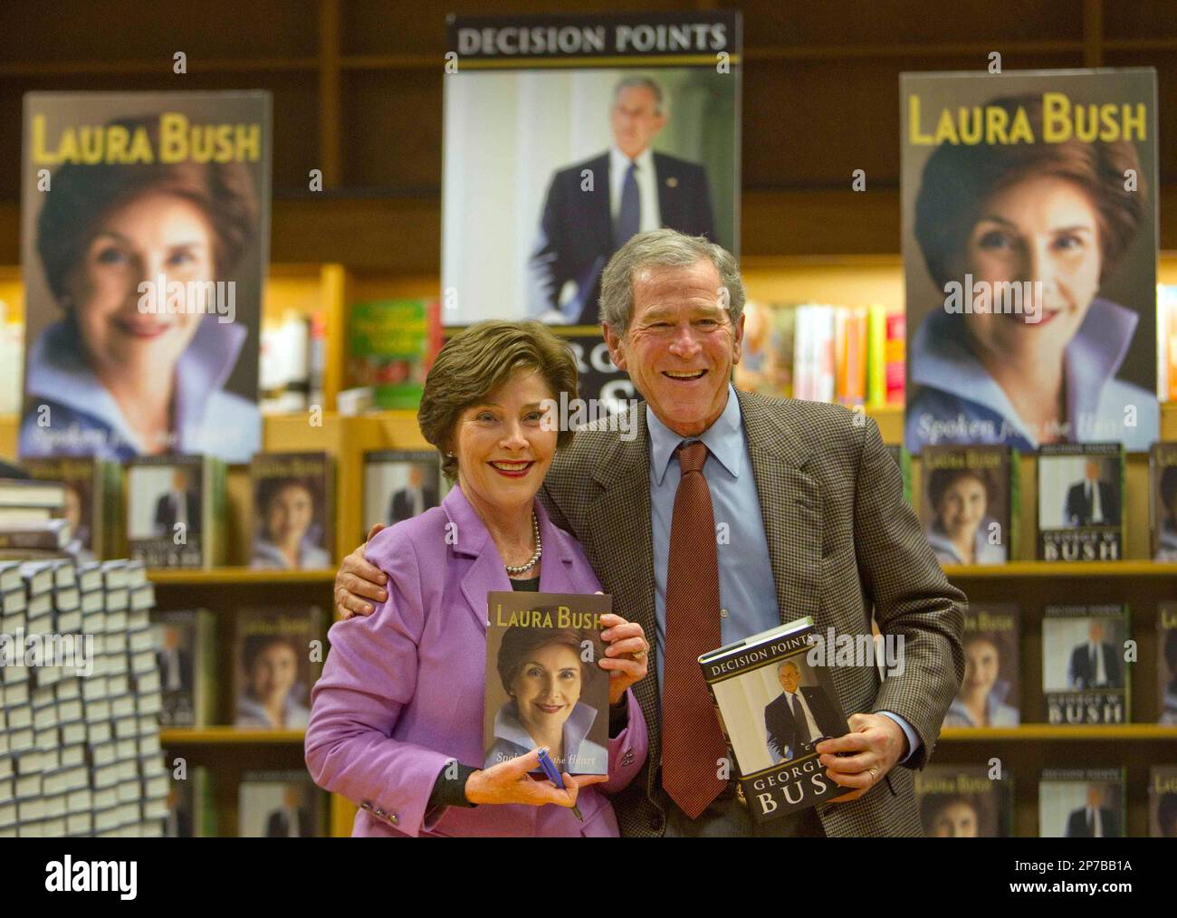 Former President George W. Bush, right, and his wife Laura appear ...
