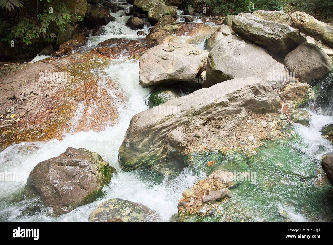 Peaceful shot of the hot spring of Malanage on Flores flowing down ...