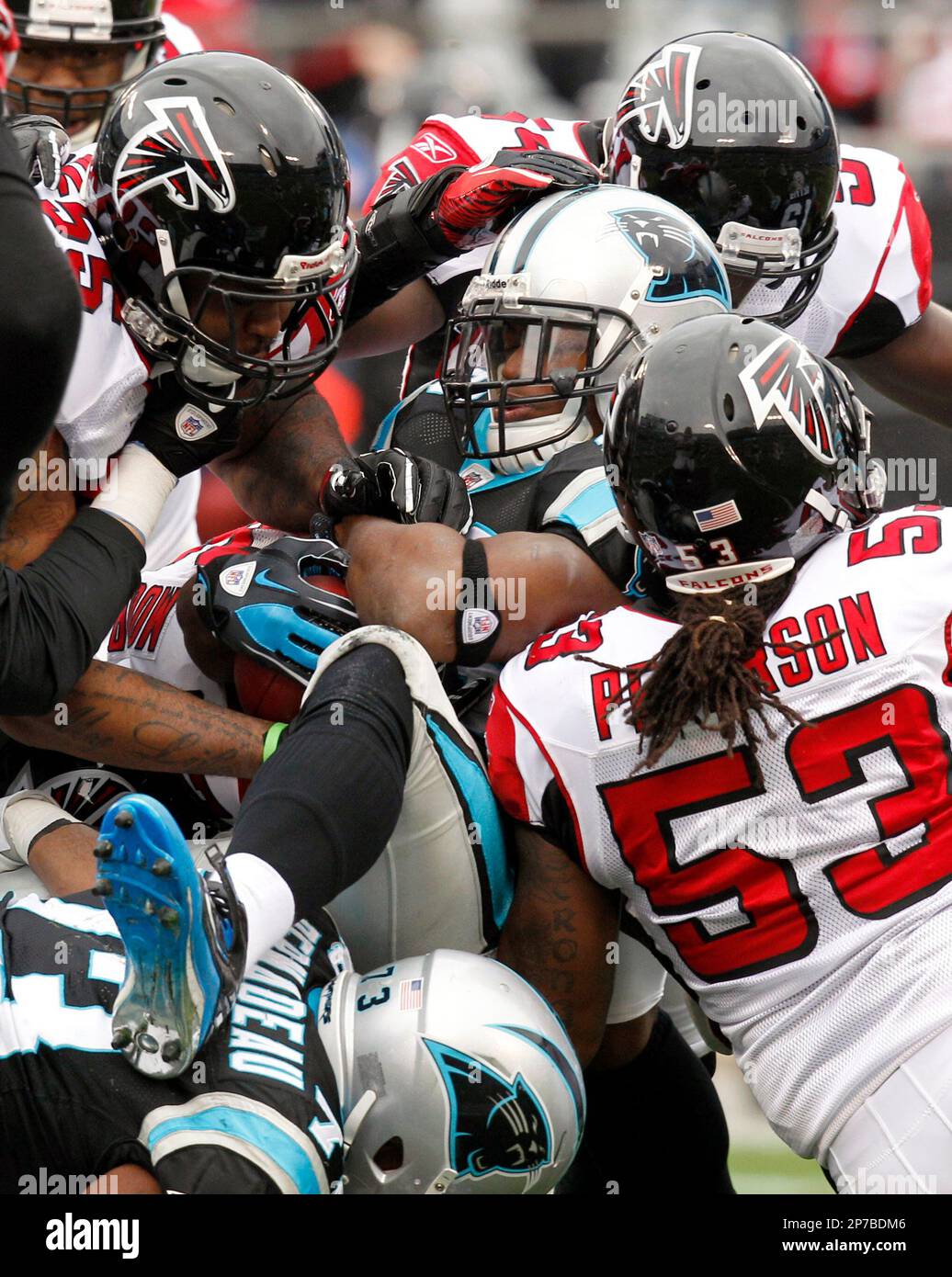 Carolina Panthers' Jonathan Stewart, center, is tackled by a host of ...