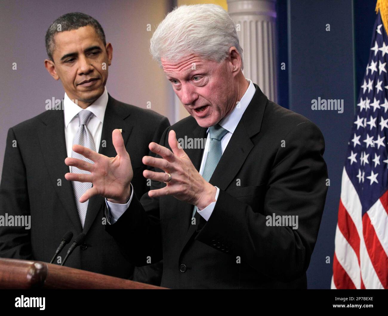 President Barack Obama looks on as former President Bill Clinton speaks ...