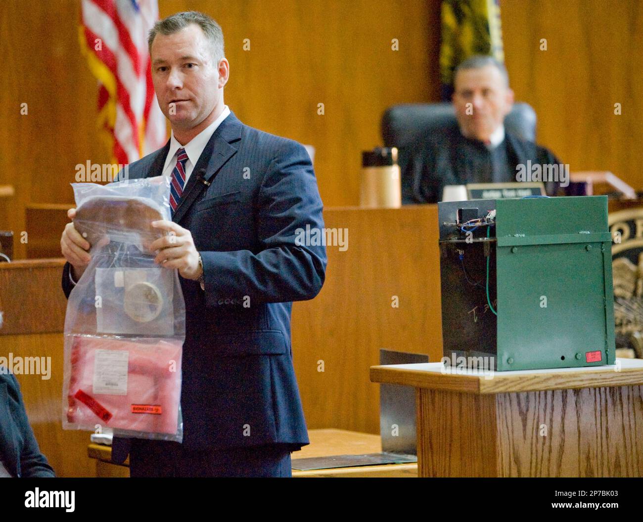 Matt Kemmy, Marion County Deputy District Attorney, holds sections of ...