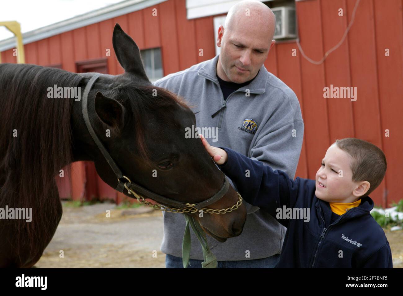 Kent State basketball coach Geno Ford keeps a close watch as his son ...