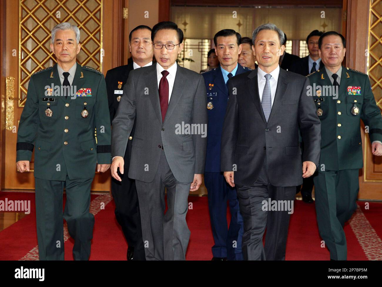 South Korean President Lee Myung-bak, center left, walks with newly ...