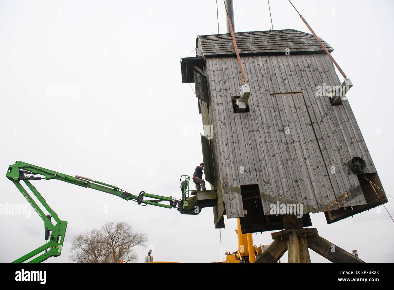 Etingen, Germany. 08th Mar, 2023. A worker climbs from a lifting ...