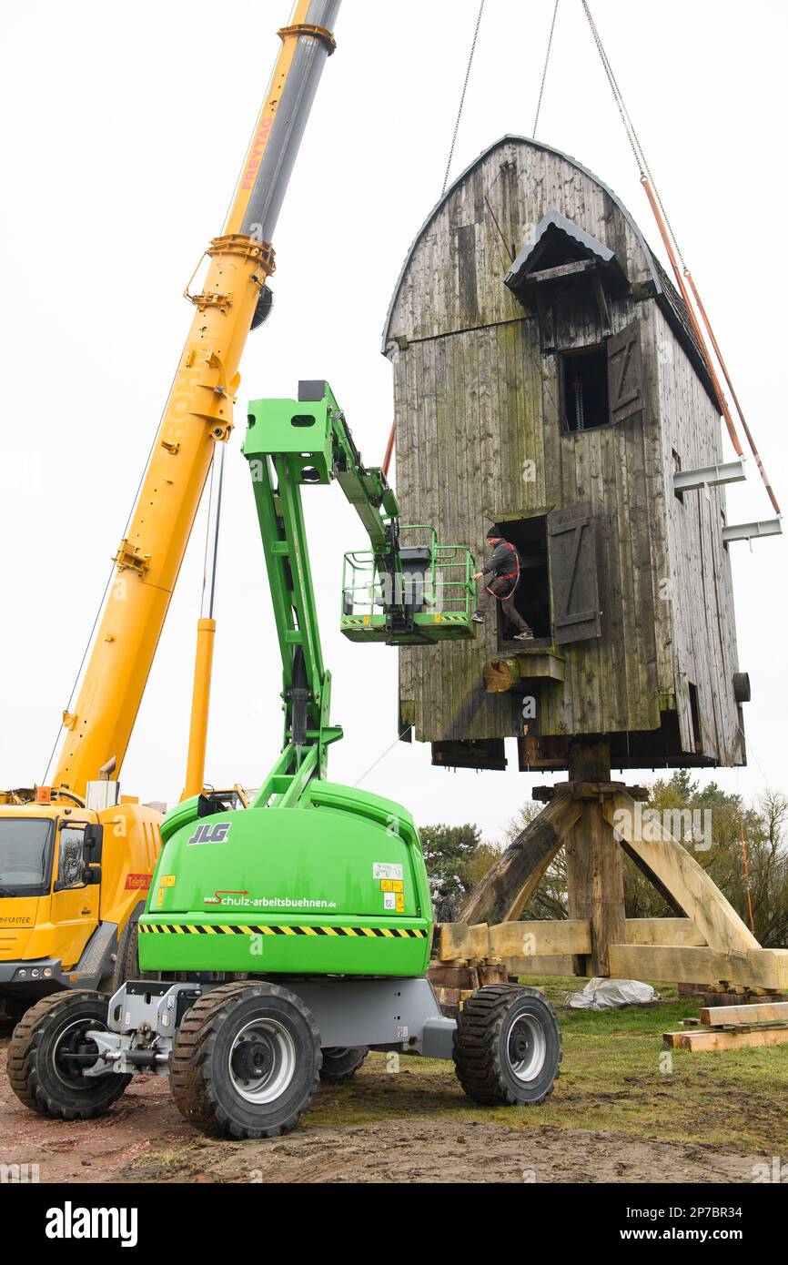 Etingen, Germany. 08th Mar, 2023. A worker climbs out of the house of ...