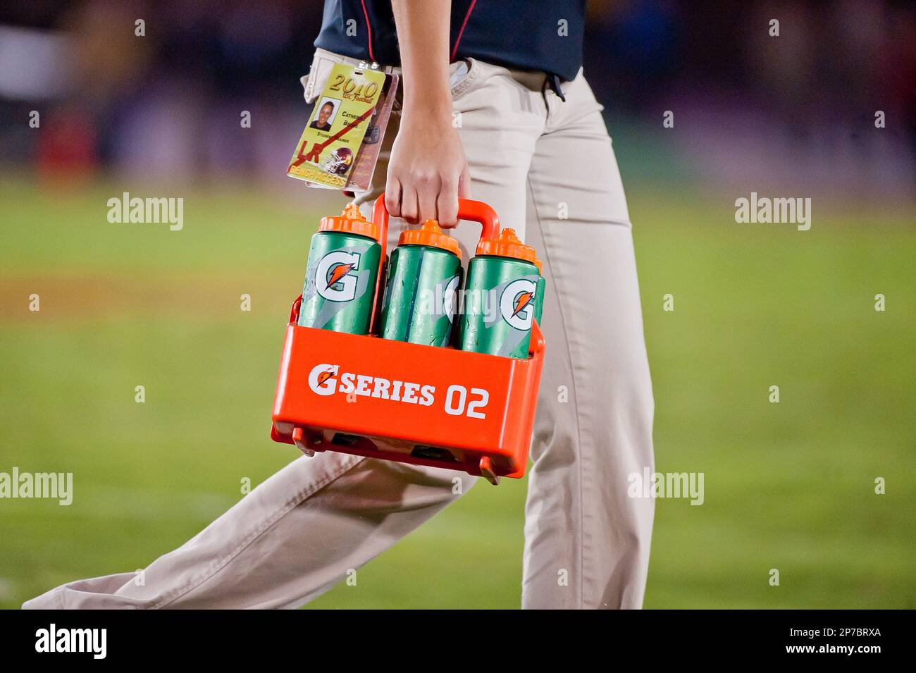 A detail of a trainer holding Gatorade bottles while the University of ...