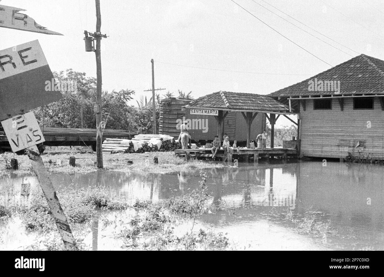 Victims of flooding due to Hurricane Hilda stand on a porch in Santa ...