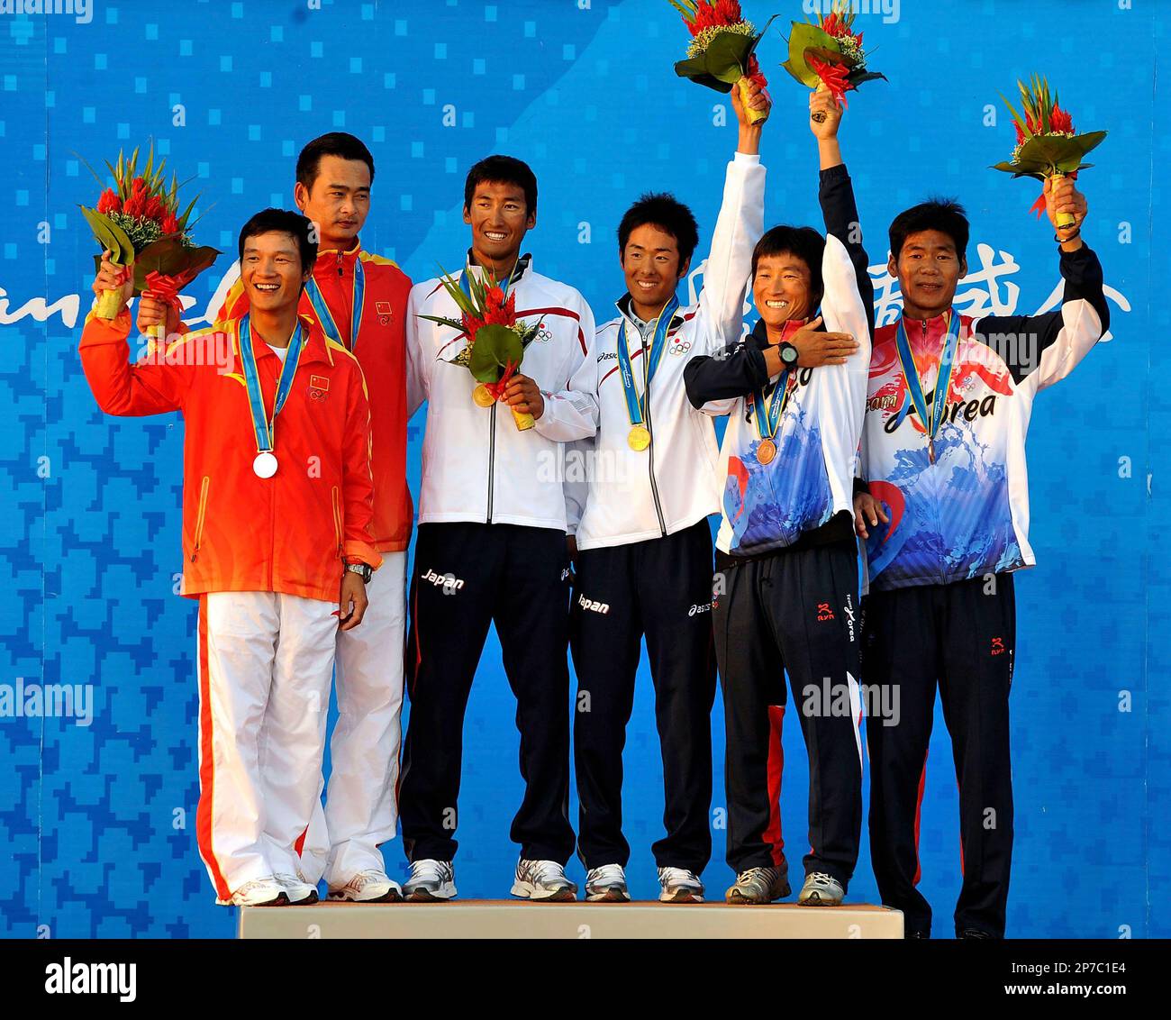 Silver winners Wang Weidong and Deng Daokun of China, left, gold winners Ryunosuke Harada and ...
