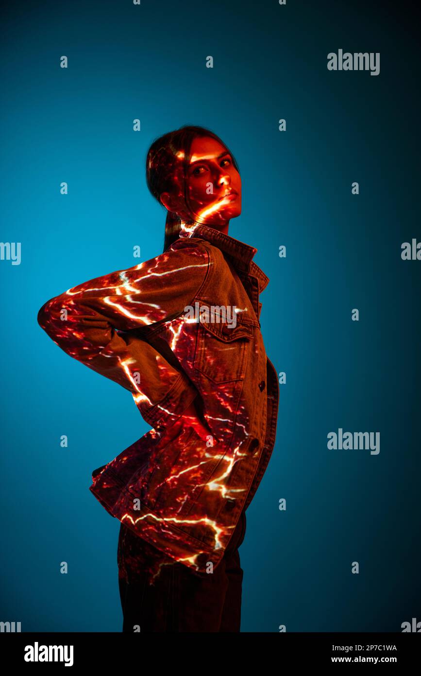 Energy. Futuristic style portrait of young woman with digital neon ...