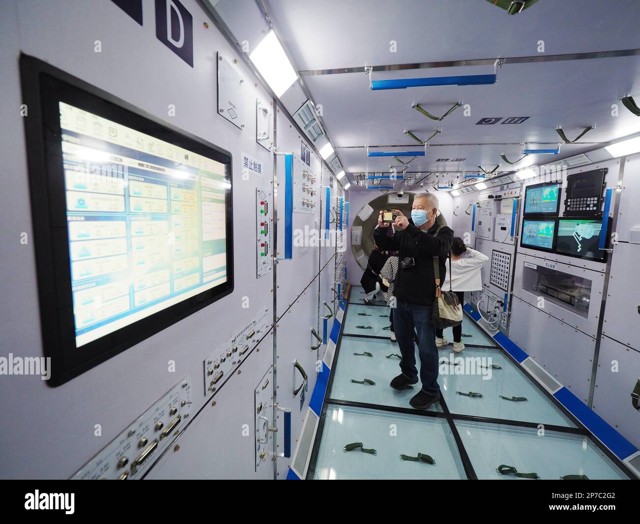 BEIJING, CHINA - MARCH 8, 2023 - Visitors look inside the model of ...