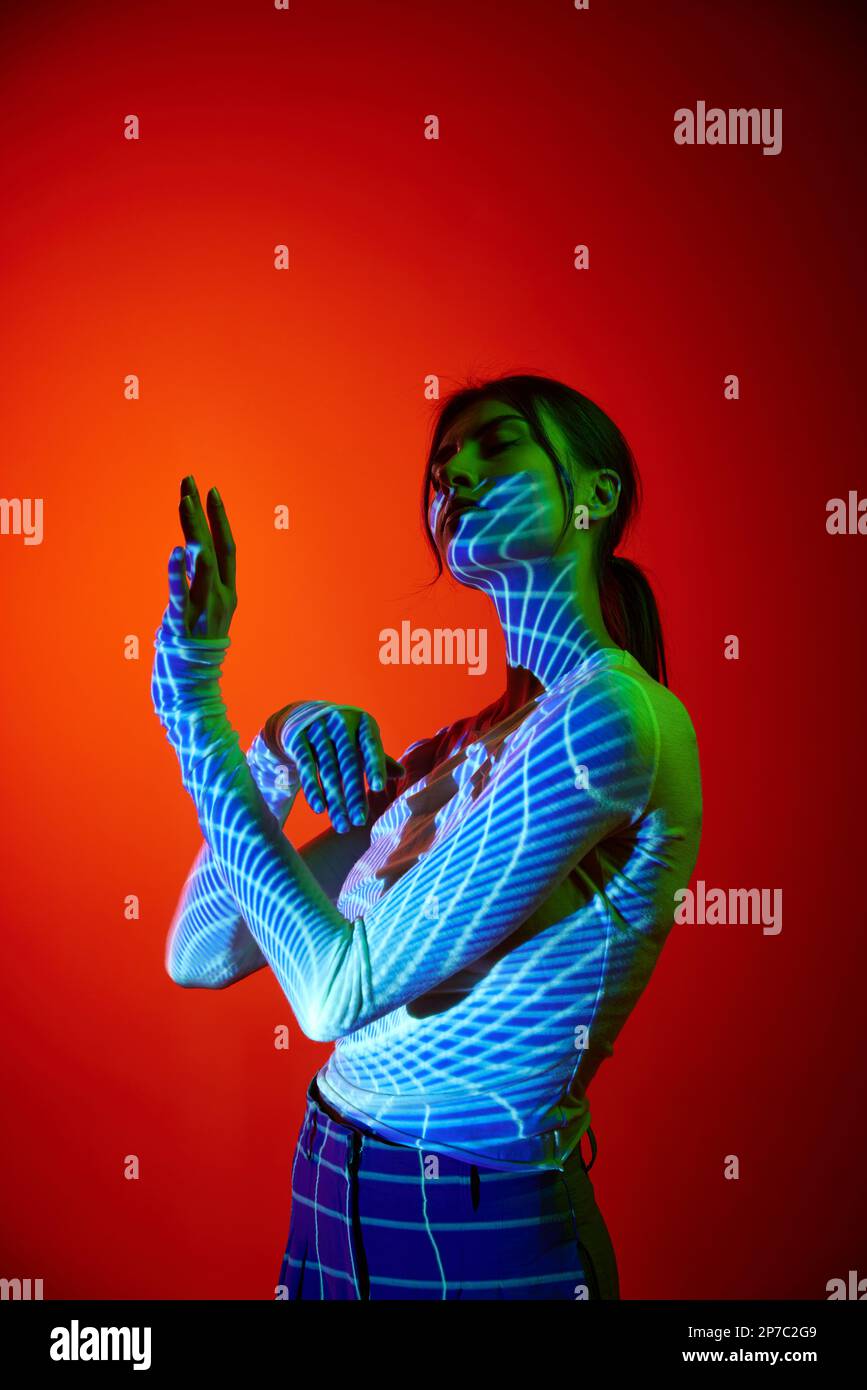 Young beautiful woman's portrait with digital neon filter lights on ...