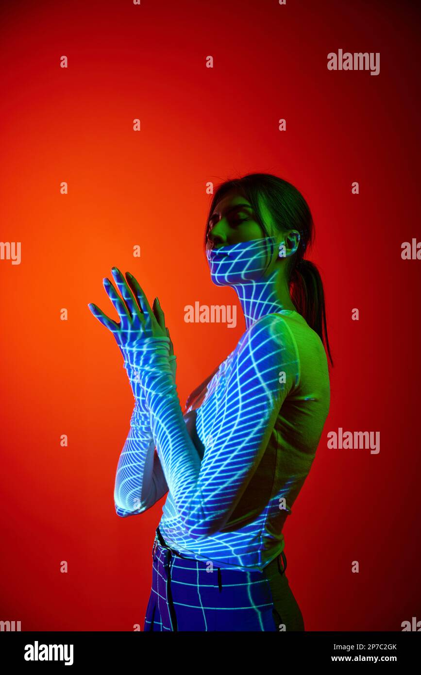 Young beautiful woman's portrait with digital neon filter lights on ...