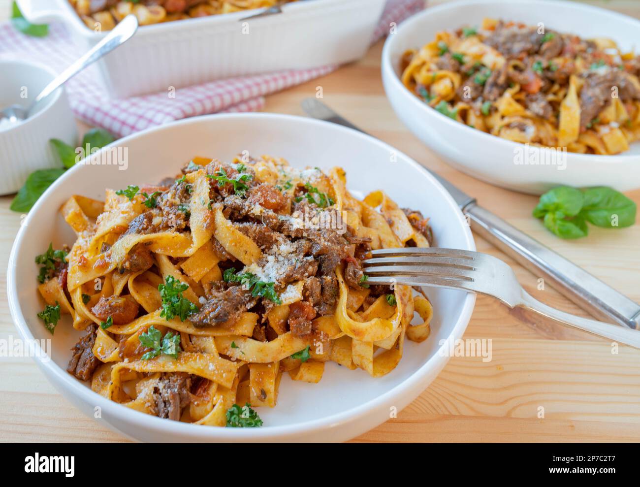 Pasta with italian beef stew and vegetables on plates Stock Photo - Alamy