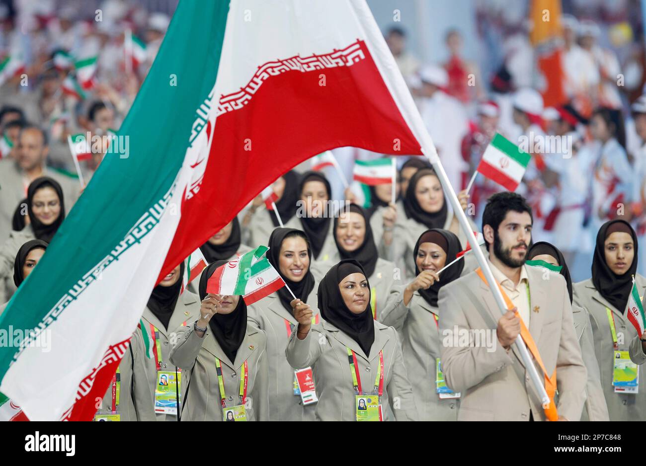 The Iranian team marches into the opening ceremony for the 16th Asian ...