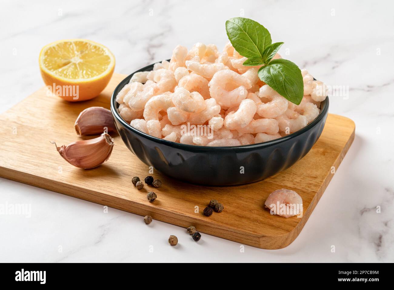 Frosen shrimps in a bowl prepared for cooking. Boiled peeled prawn ...