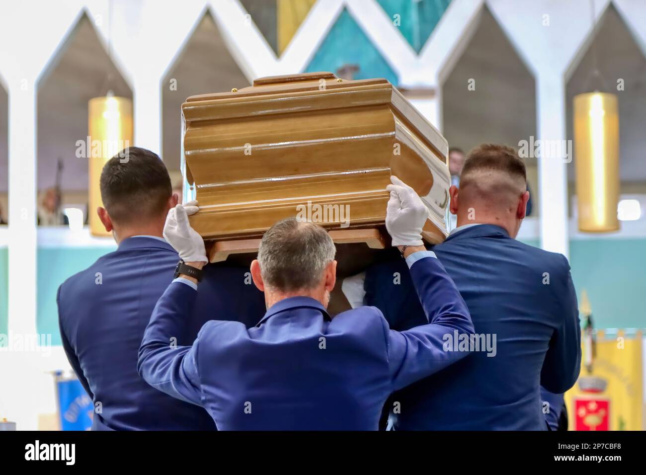 Undertakers carry a coffin to the church altar for the funeral Stock ...