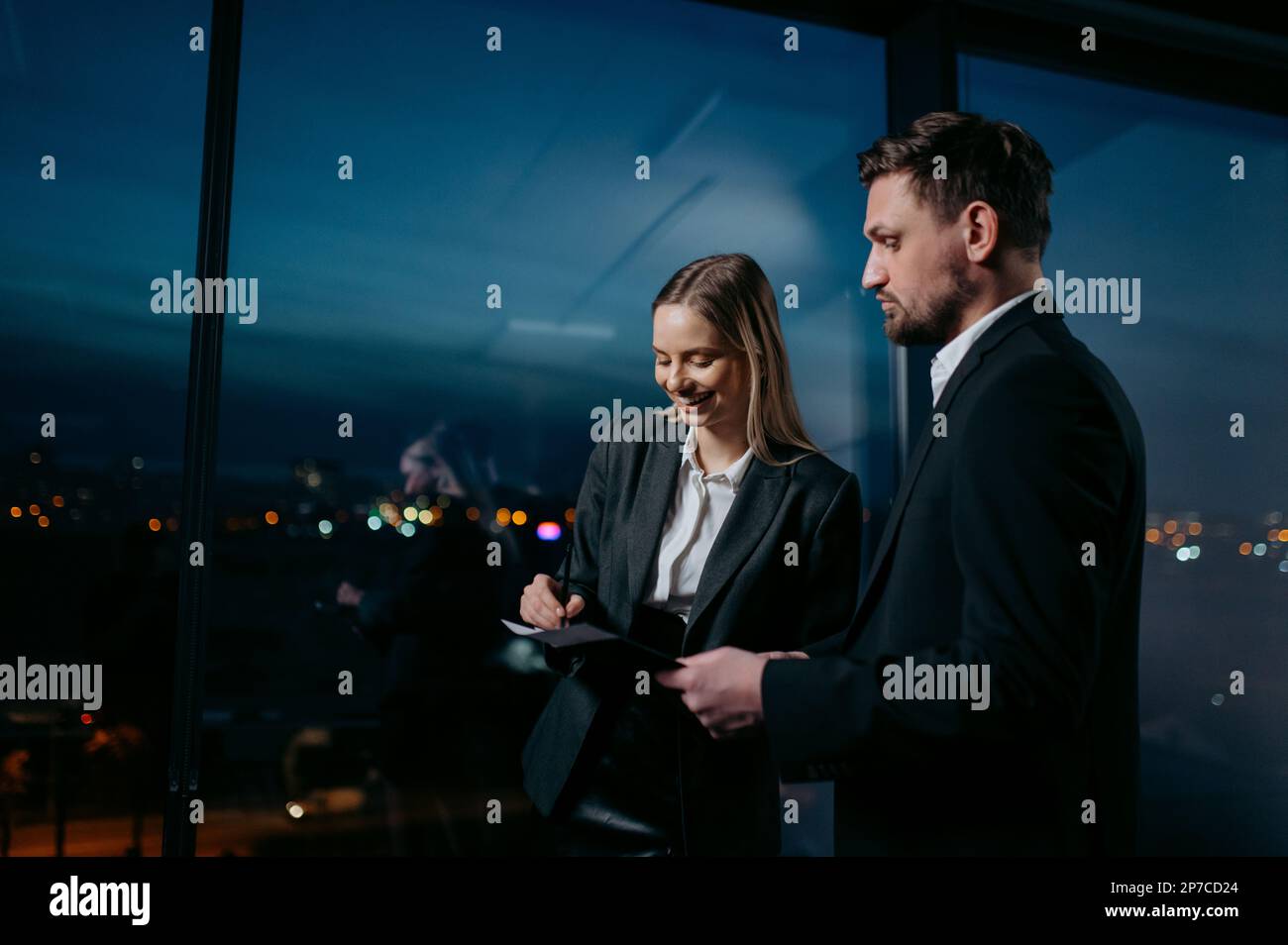 male and female office workers talking. Business partners talking in ...