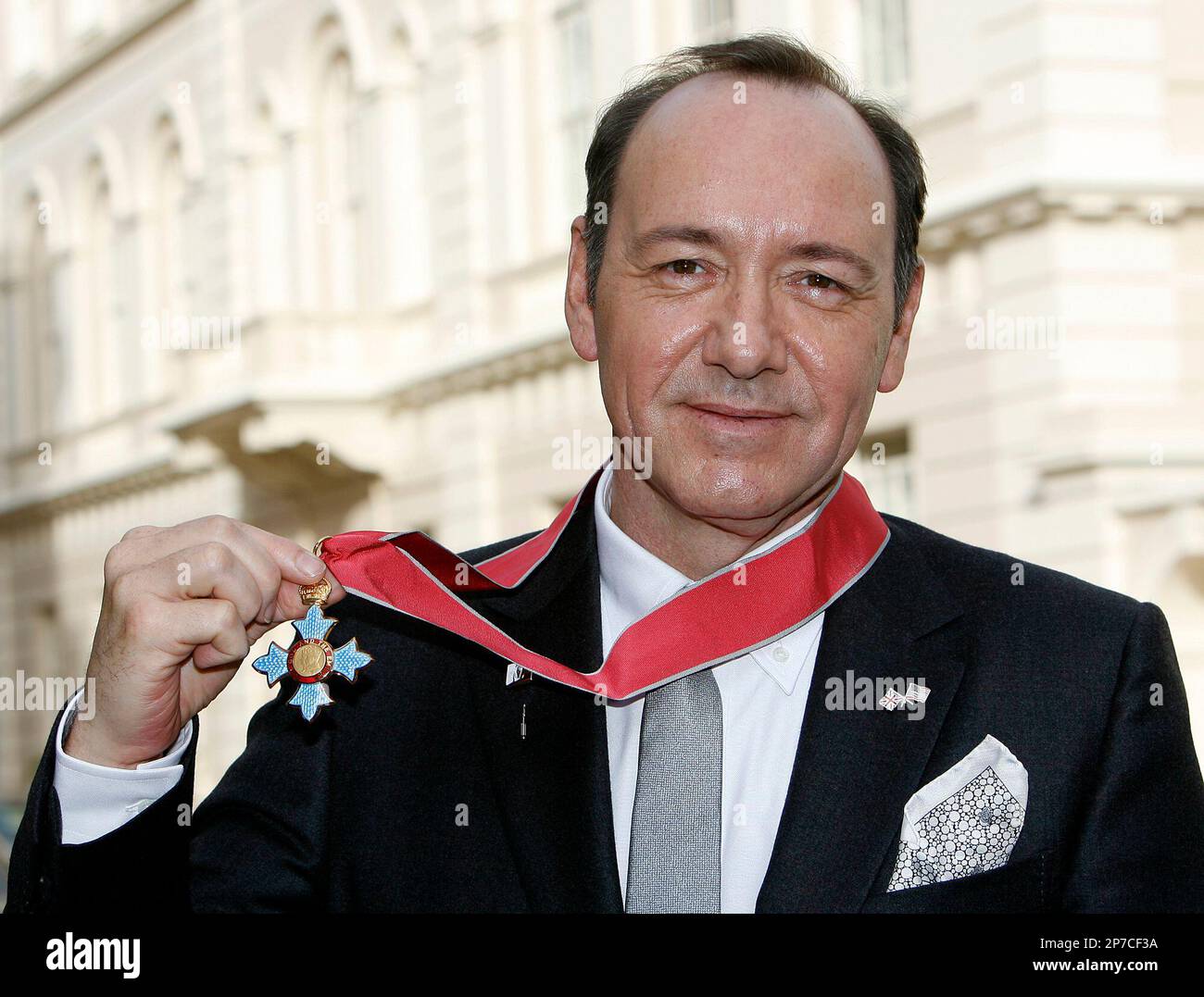 U.S. actor Kevin Spacey poses for photographs with his honorary CBE ...